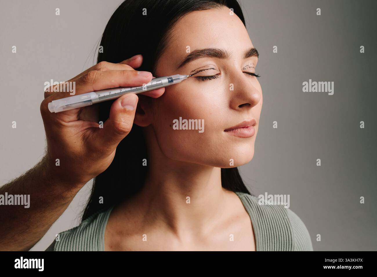 Surgeon is planning upper blepharoplasty with marker. Surgeon is ...