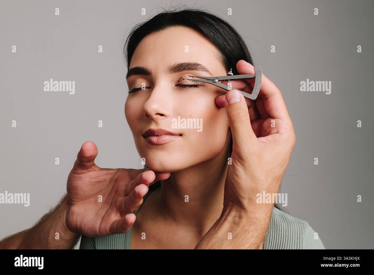 Blepharoplasty marking up. Plastic surgeon is measuring distance in ...
