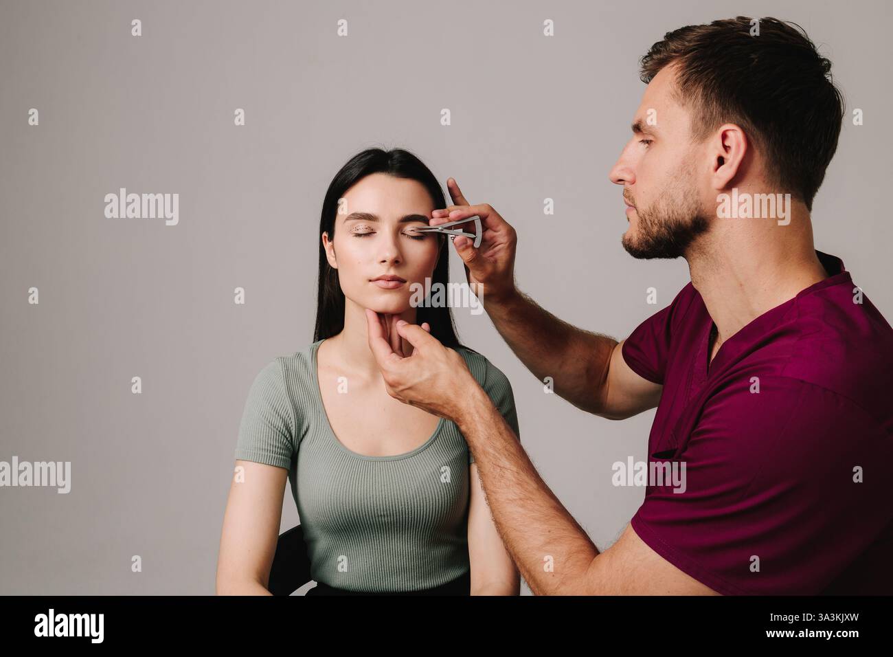 Blepharoplasty marking up. Plastic surgeon is measuring distance in ...