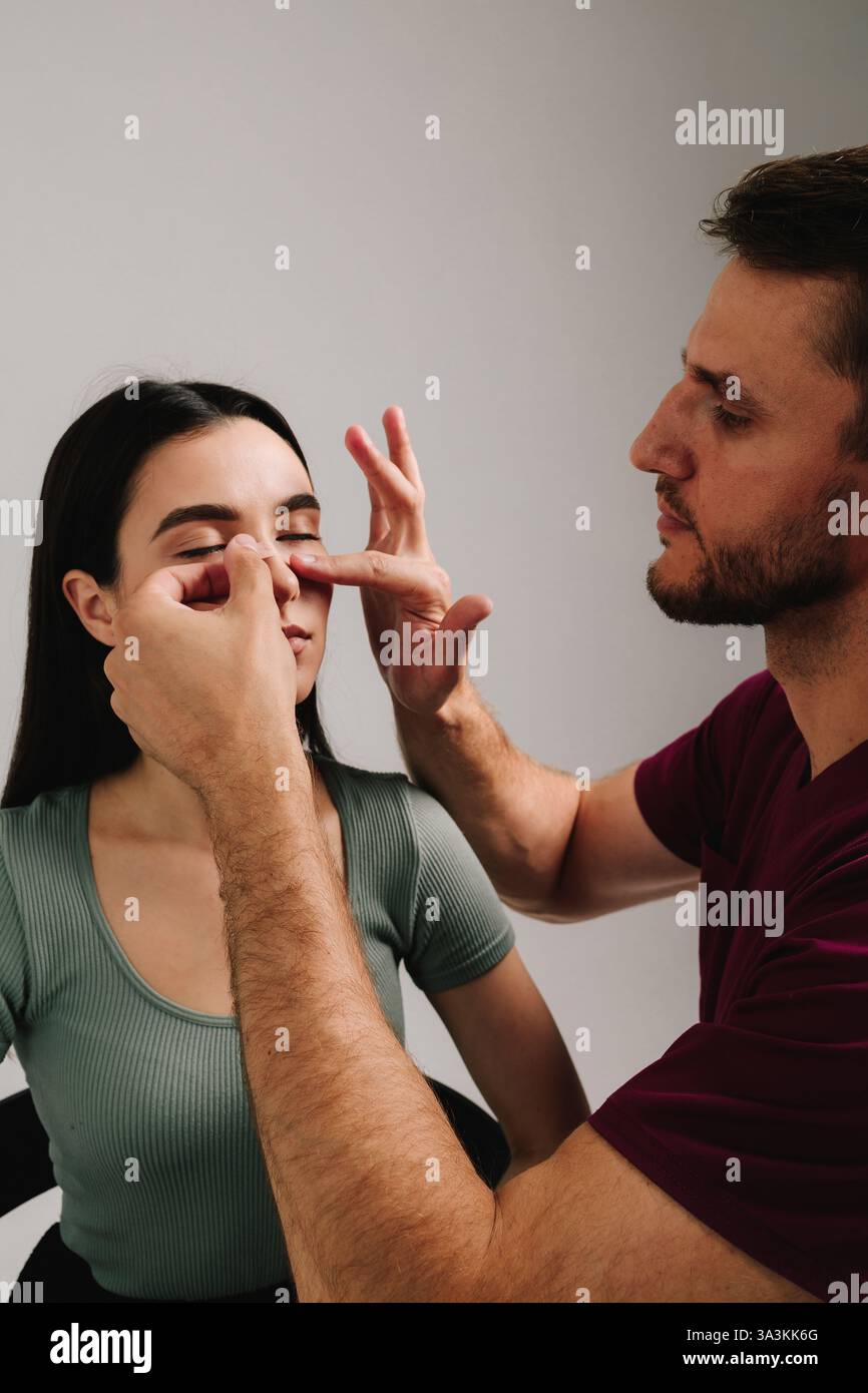 Rhinoplasty. Plastic surgeon is taping nose to patient during ...