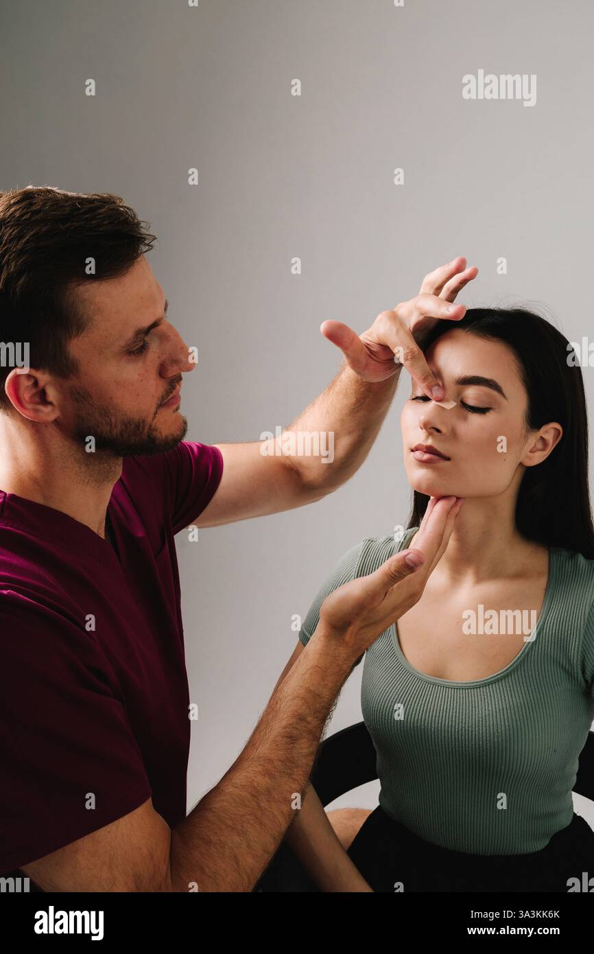 Rhinoplasty. Plastic surgeon is taping nose to patient during ...
