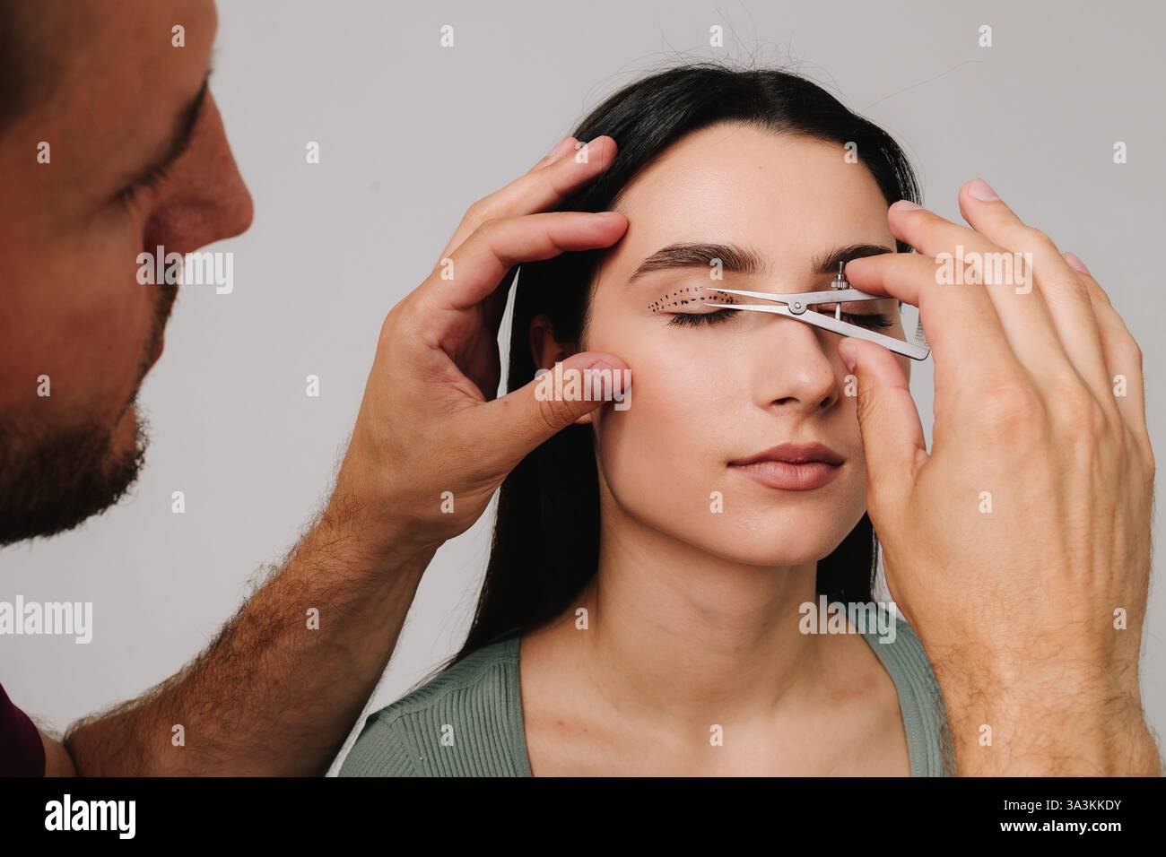 Plastic surgeon is measuring surgical distance within eye of his ...