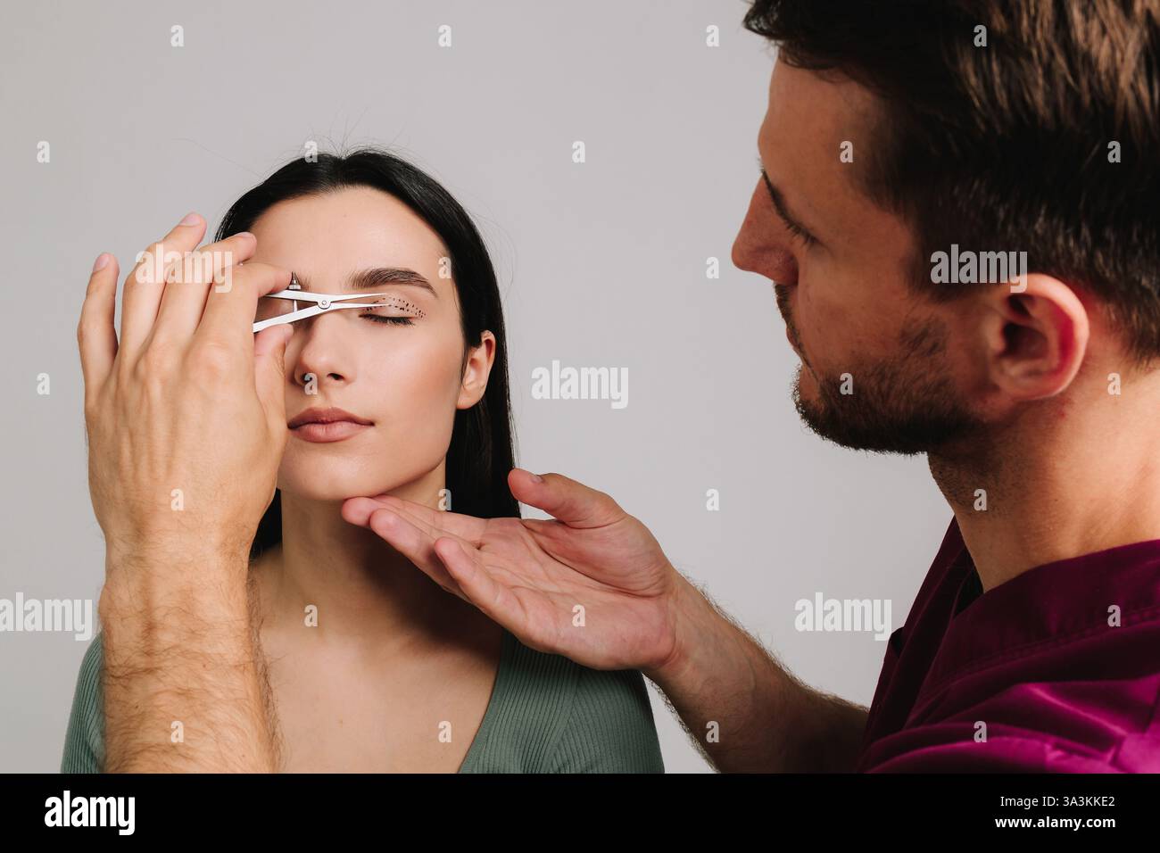 Plastic surgeon is measuring surgical distance within eye of his ...