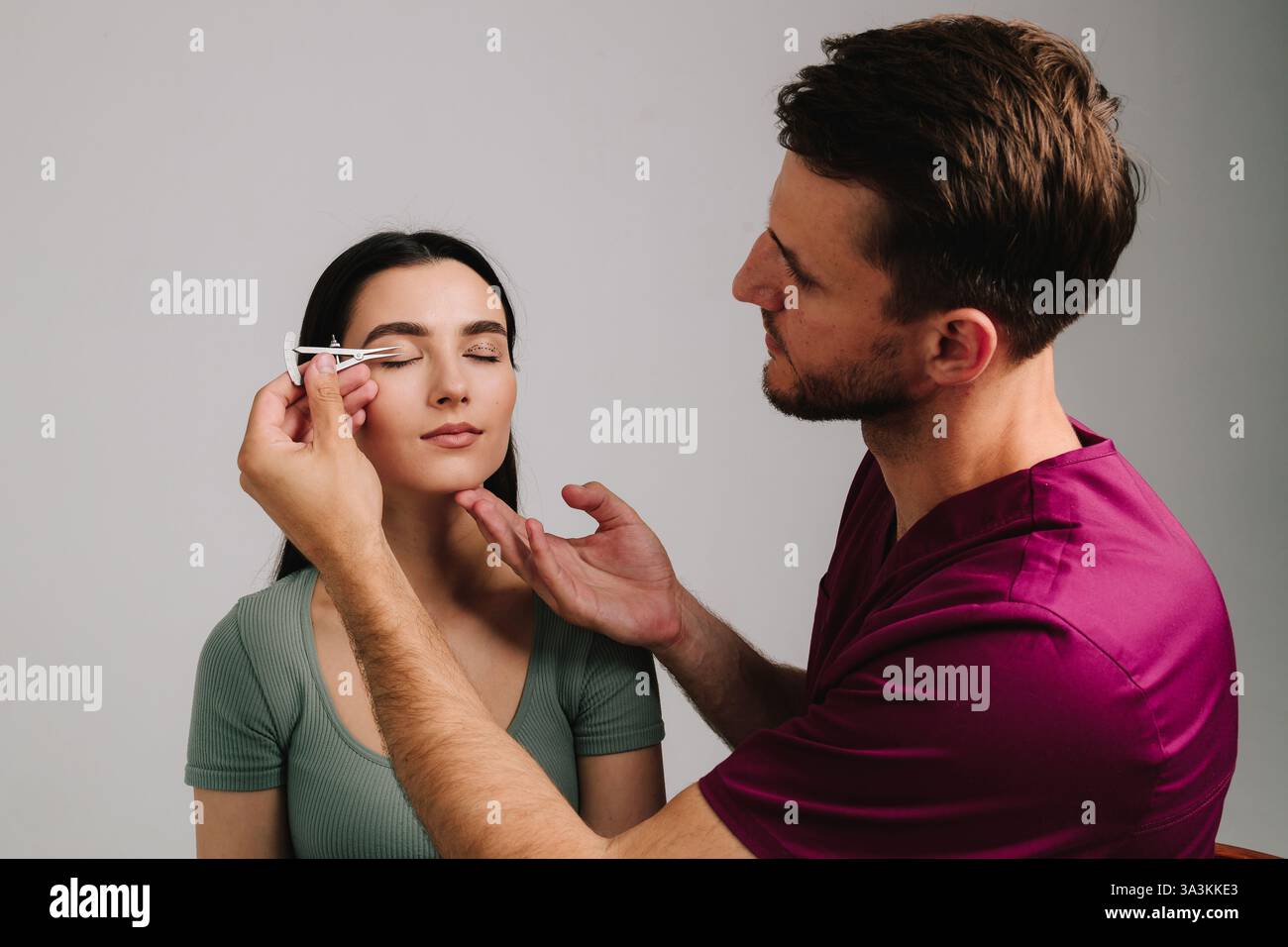 Upper blepharoplasty. Plastic surgeon is measuring surgical distance ...