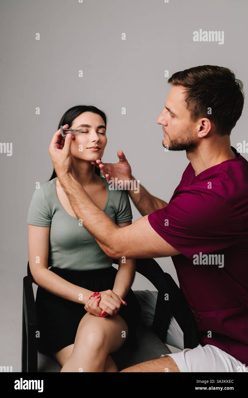 Blepharoplasty marking up. Plastic surgeon is measuring distance in ...