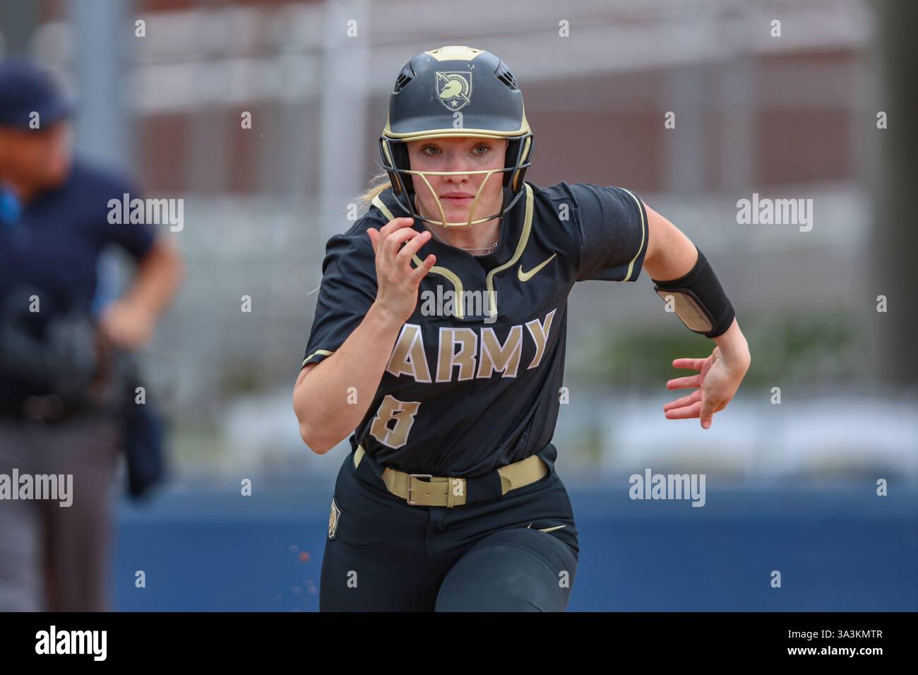 Army catcher Sam Rodgers (8) runs to first base during an NCAA softball ...
