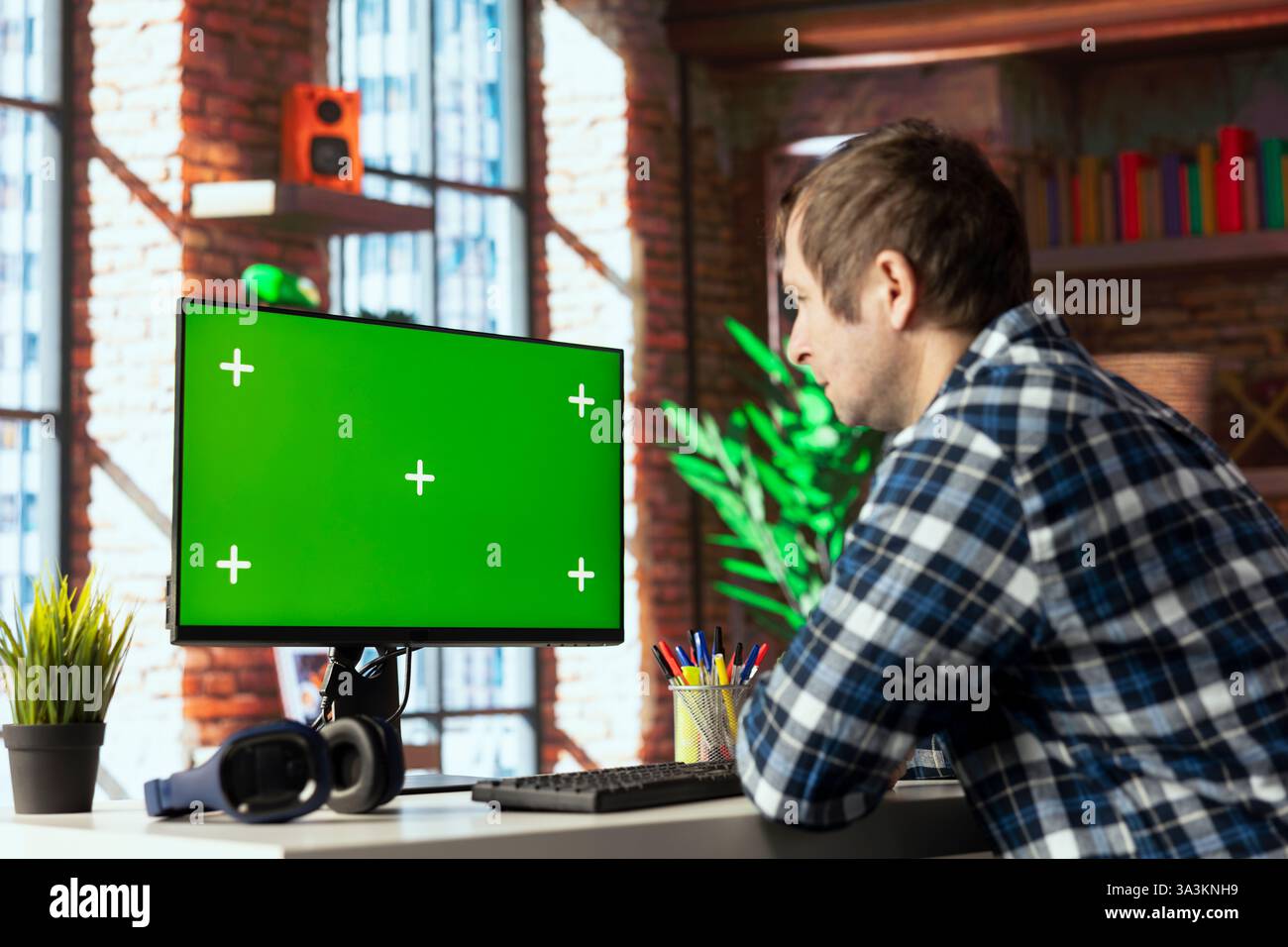 Teleworker in home office editing documents on mockup computer, updating reports and files ...
