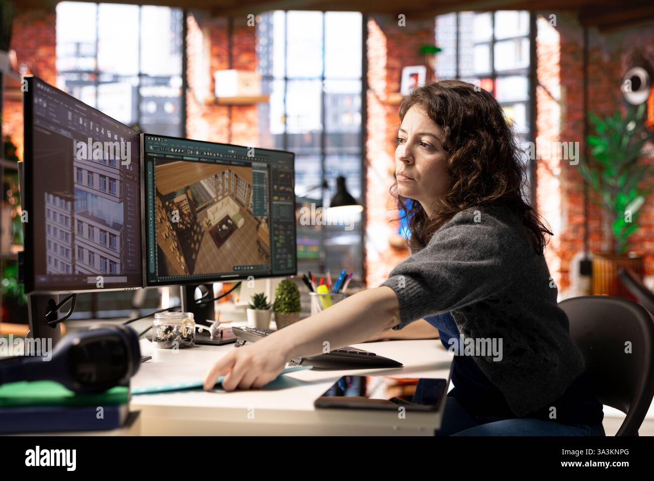 Worker in a creative office uses CAD software to design a house ...