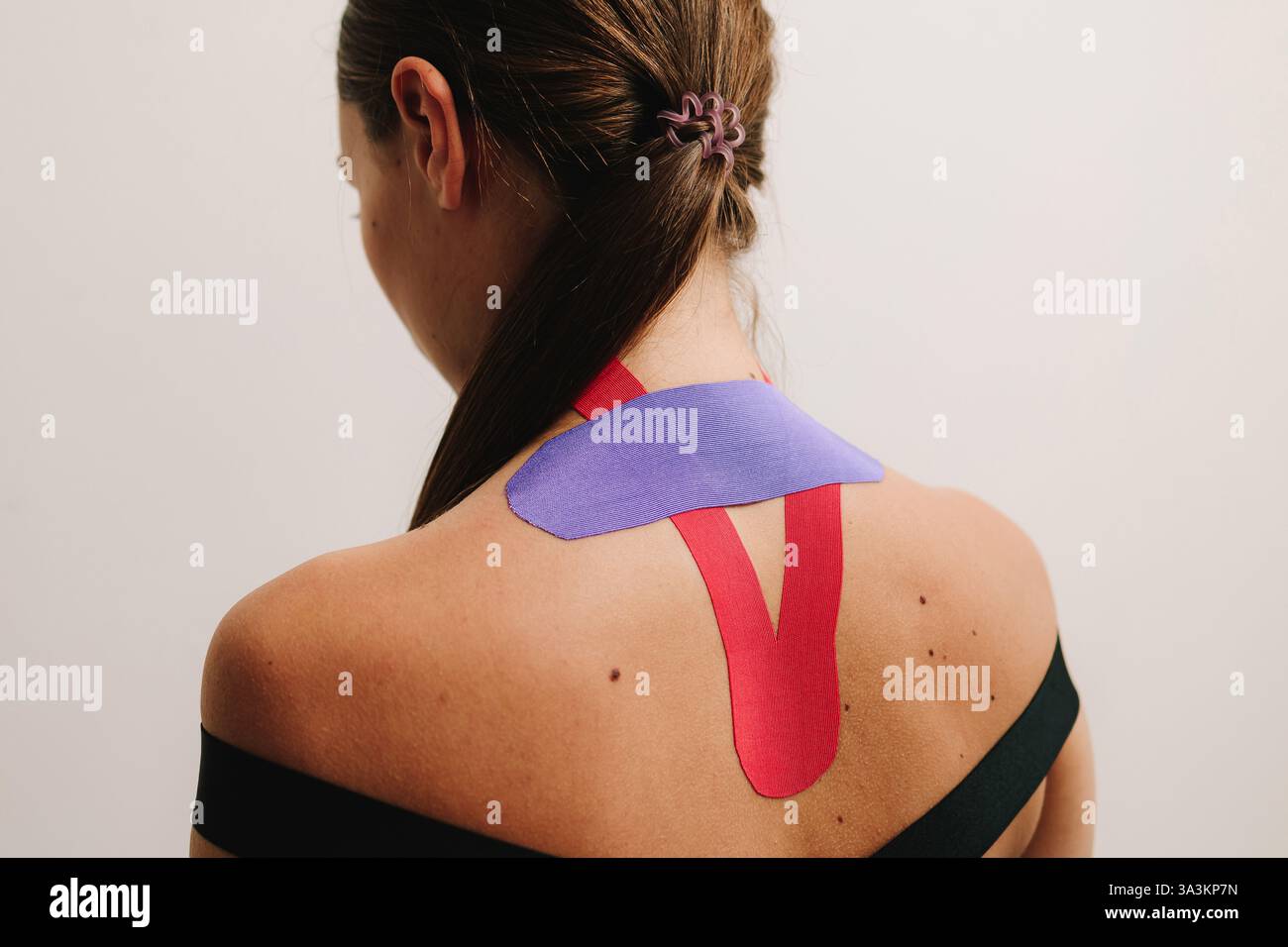 Medical tape. Doctor is applying bright kinesiology tape on athlete to ...