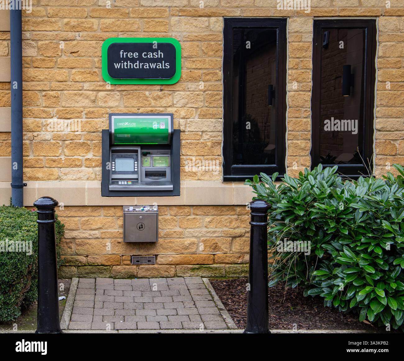 Outdoor ATM with free cash withdrawals sign against a brick wall ...