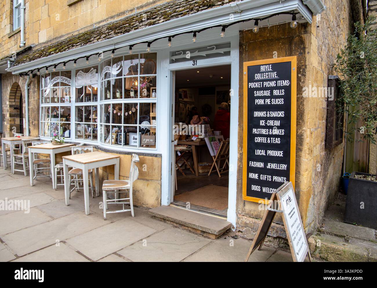 Charming local cafe with outdoor seating on a quaint street in a ...