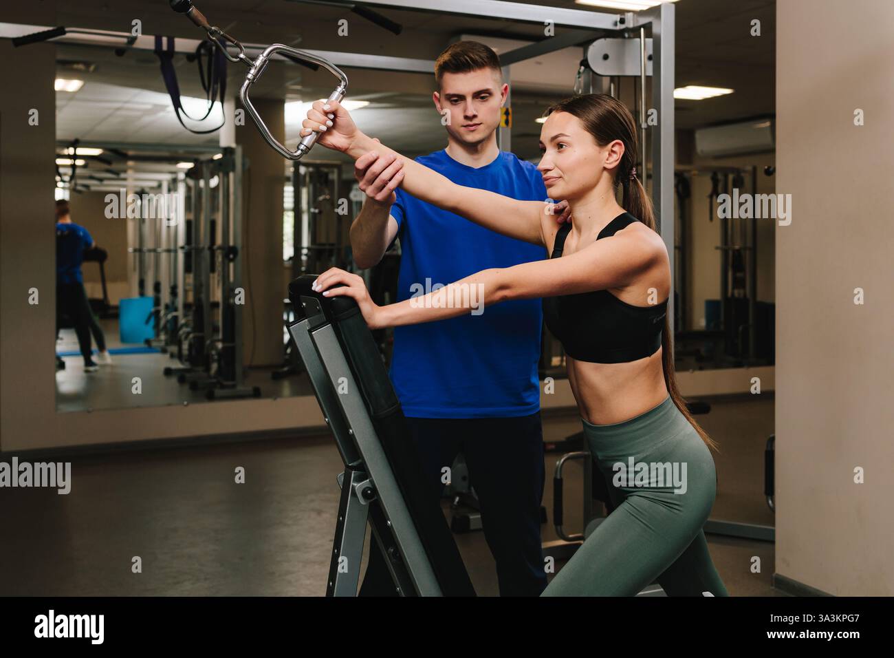 Female patient is doing kinesitherapy yo improve physical conditioning. Assisted therapeutic ...