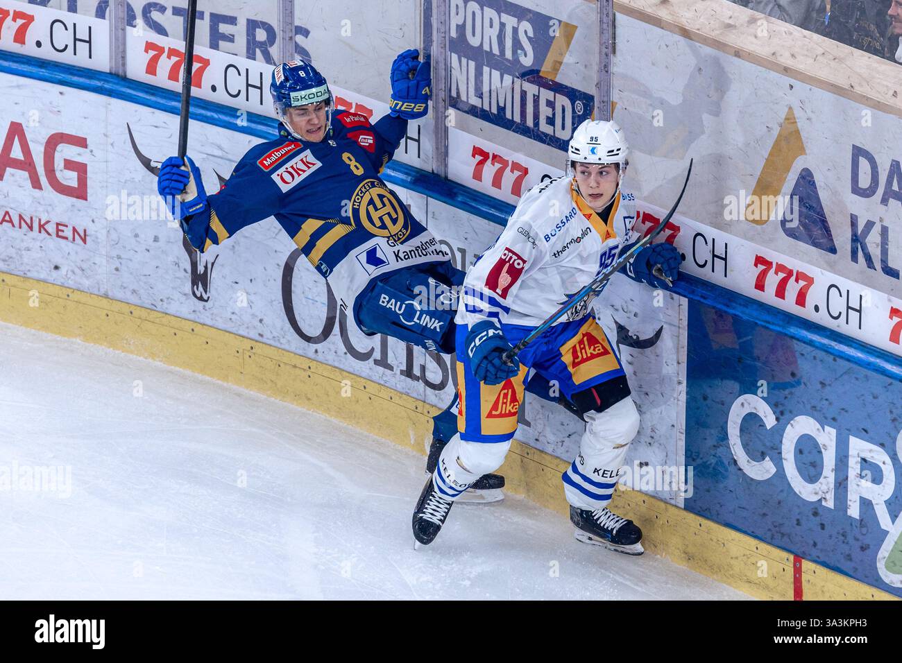Colin Lindemann #95 (EV Zug) checks Rico Gredig #8 (HC Davos) - March 16, 2025 - National League ...