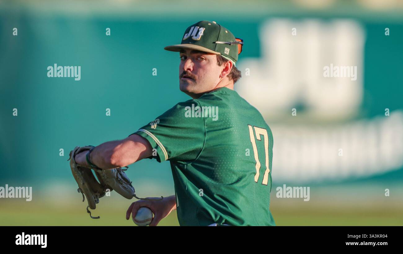 Jacksonville pitcher Aaron Zenus (17) warms up before an NCAA baseball ...