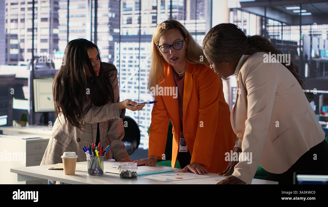 General director reviewing data analytics with her team for successful ...