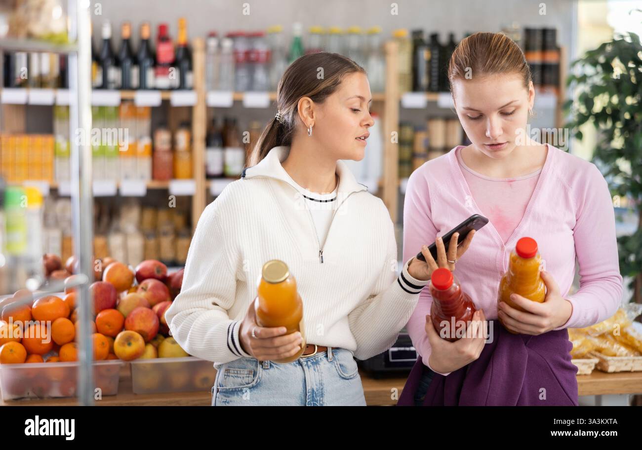 Young women scanning qr code for juices Stock Photo - Alamy
