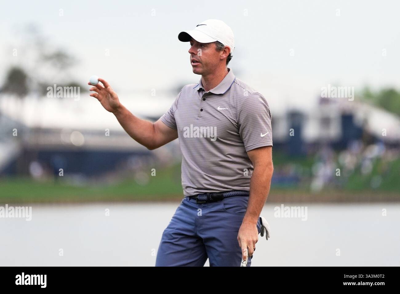 Rory McIlroy, of Northern Ireland, reacts after completing the 18th ...