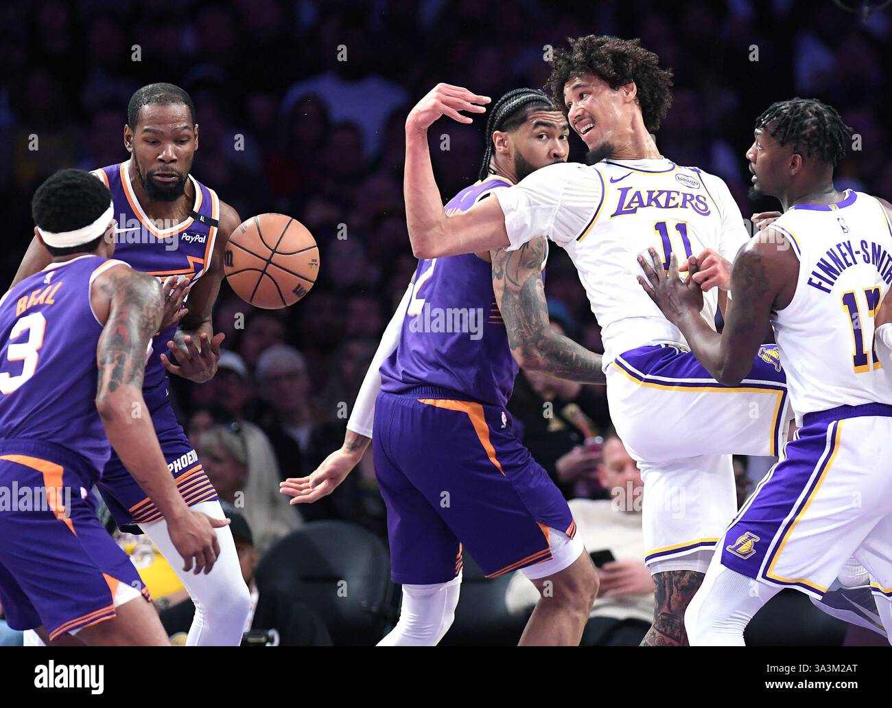From left, Phoenix Suns guard Bradley Beal, forward Kevin Durant and center Nick Richards battle ...