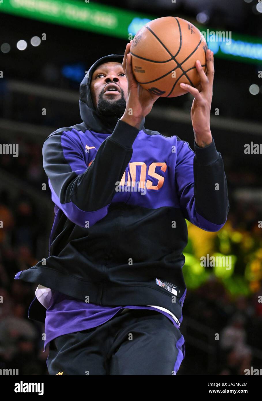 Phoenix Suns guard Devin Booker warms up before an NBA basketball game ...
