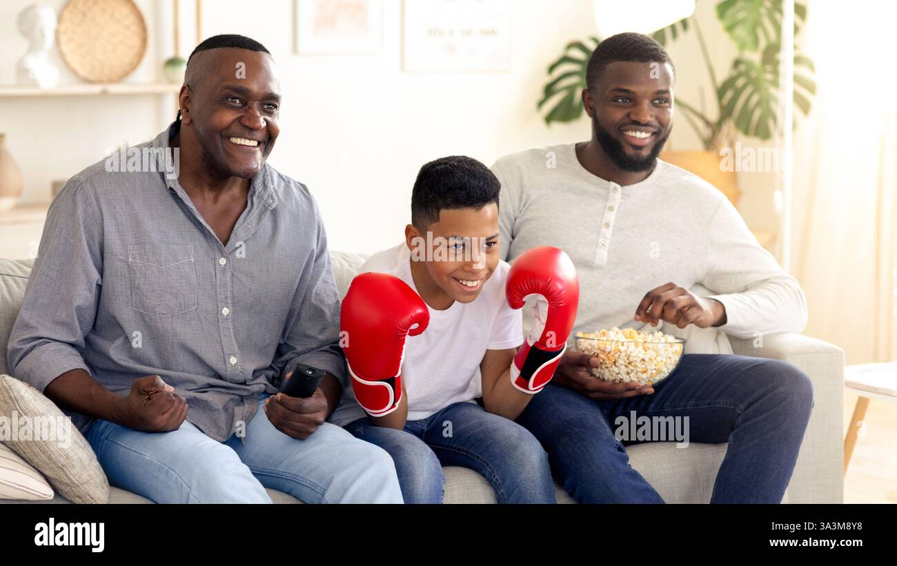 Family bonding time during a boxing match at home with snacks and ...