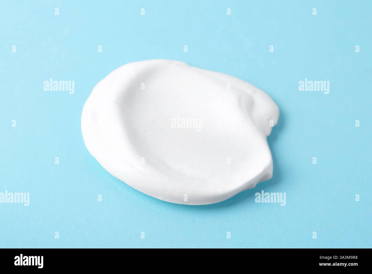 Sample of fluffy foam on light blue background, closeup Stock Photo - Alamy
