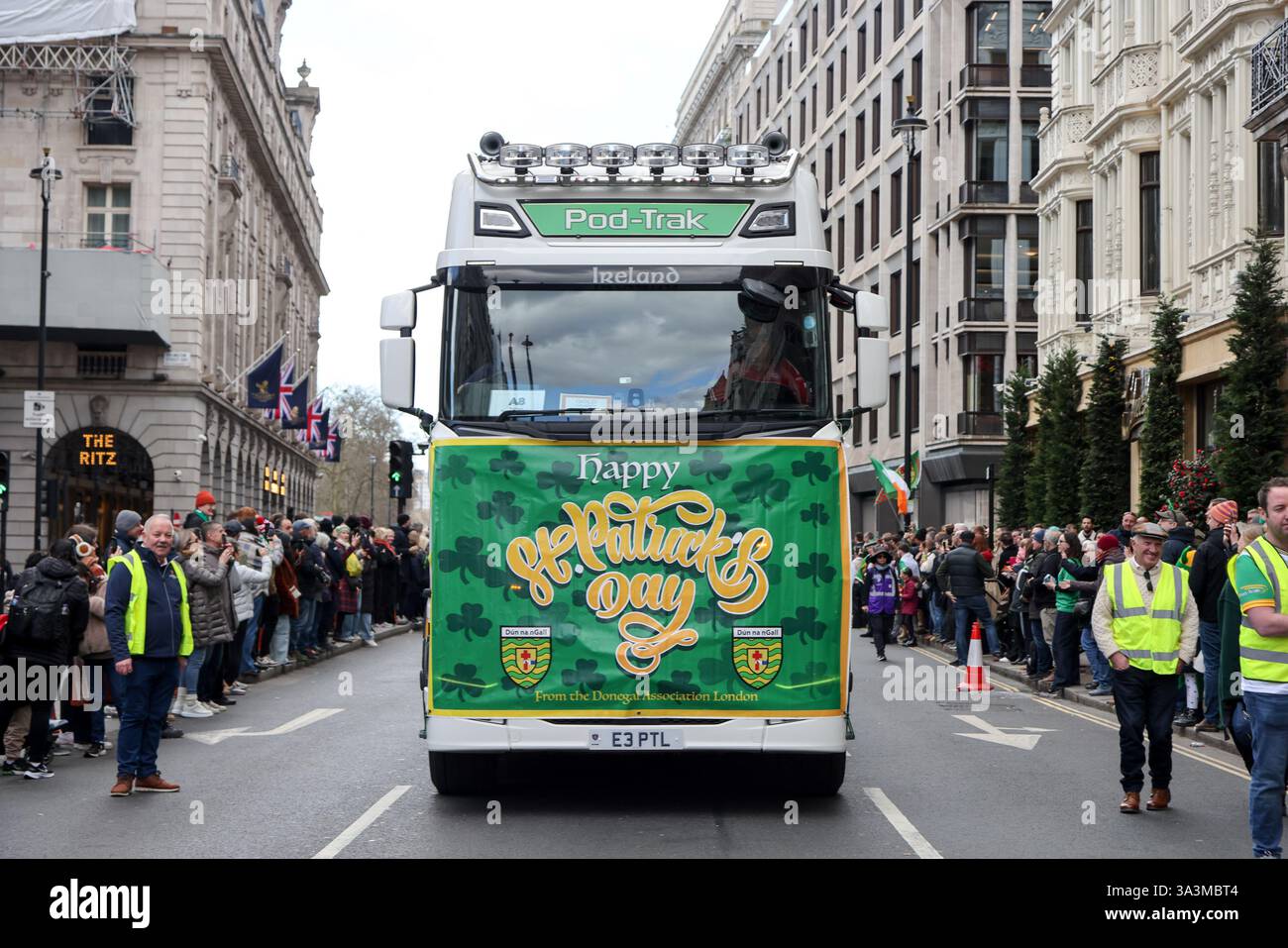 London, UK. 17th Mar, 2025. People attend the St. Patrick's Day Parade ...