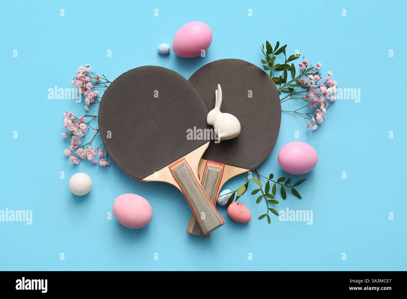 Composition with ping-pong rackets, Easter eggs and flowers on color ...