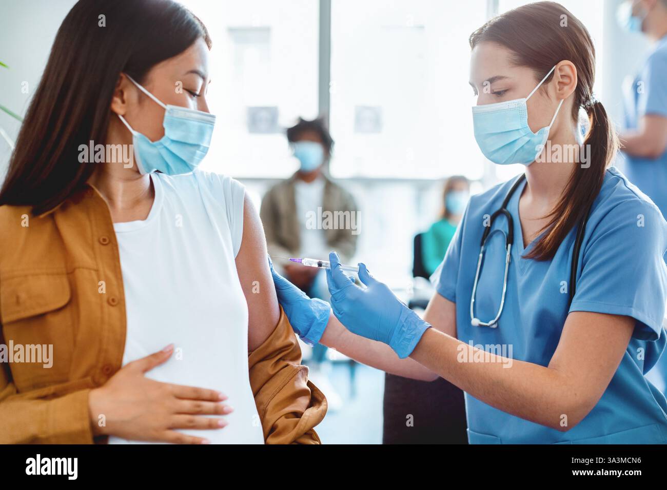 Multiracial individuals receiving flu vaccinations at a healthcare ...