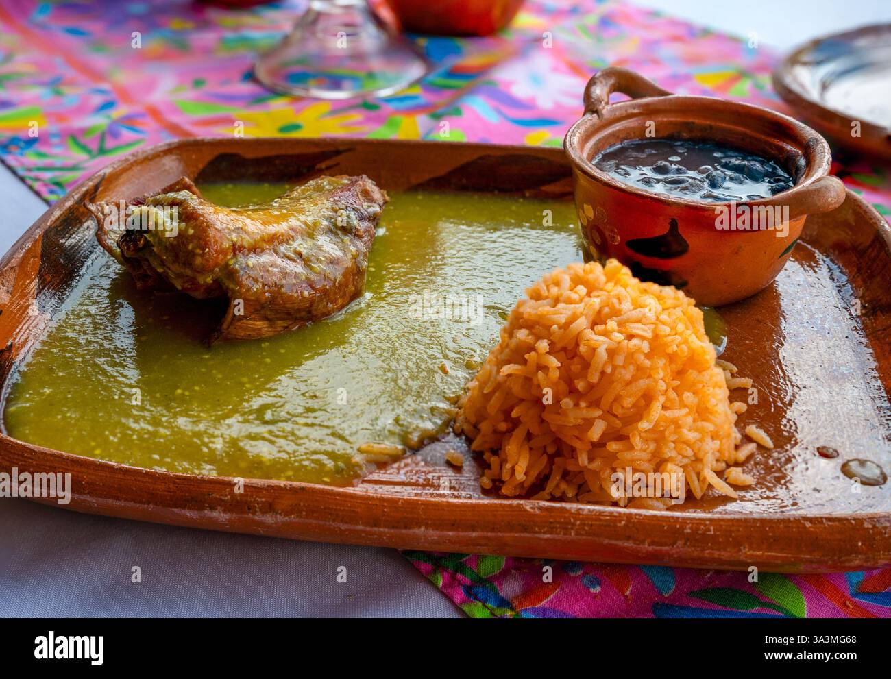 Mexican Food. Rabbit in green tomatillo salsa with Mexican red rice and ...