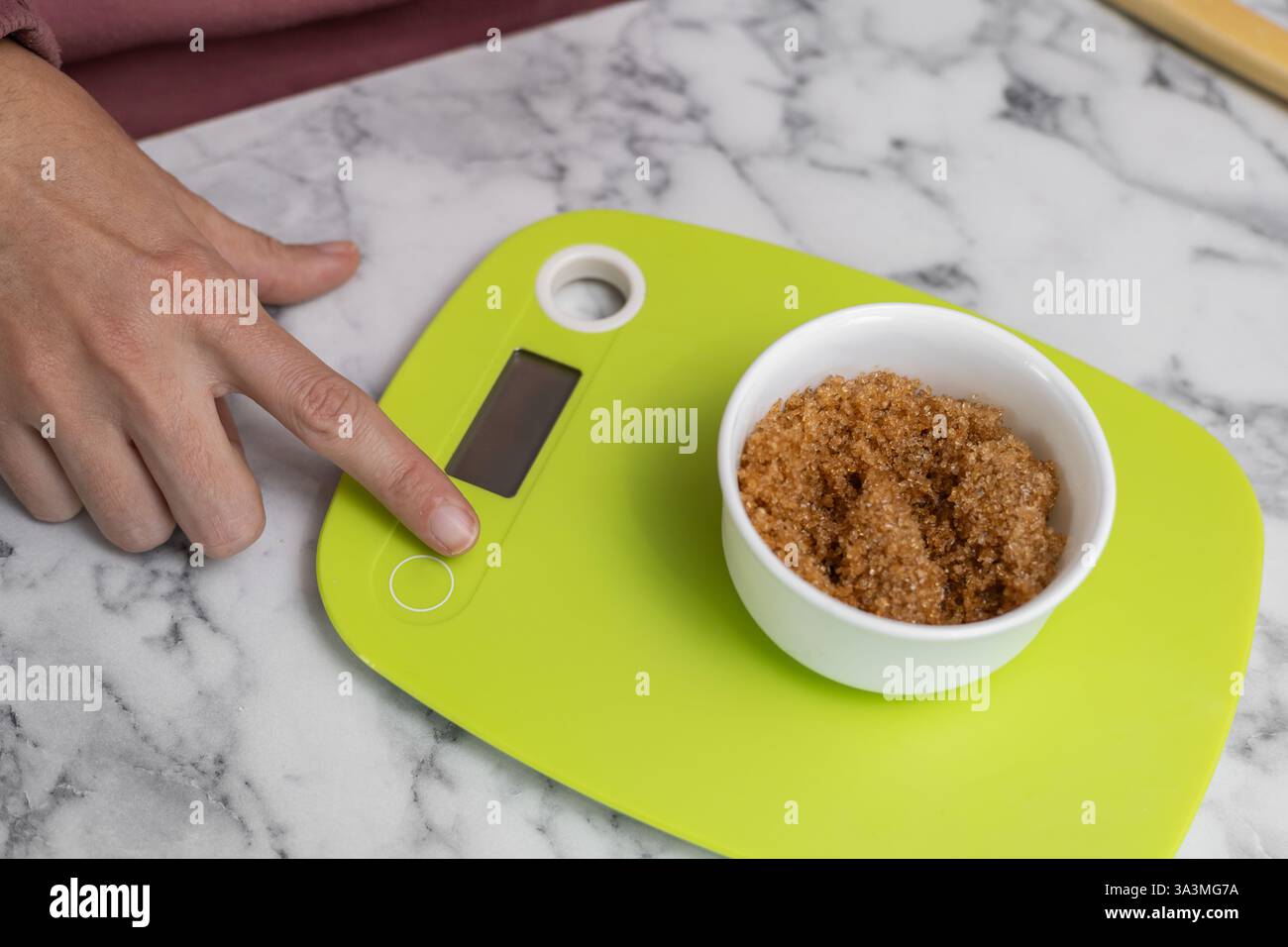 Carefully setting up the scale to measure brown sugar, ensuring the ...
