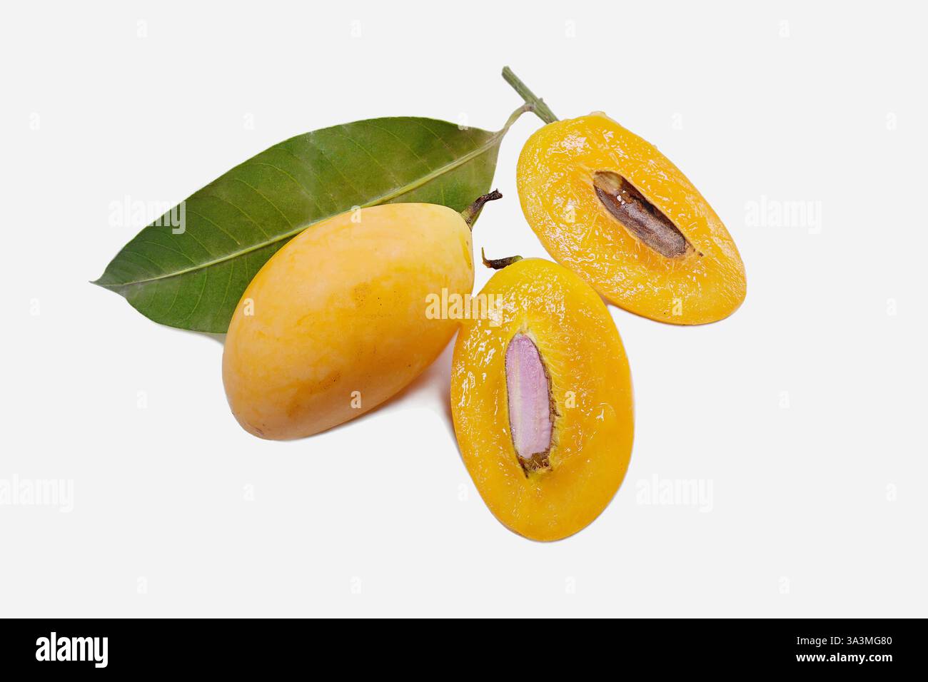 A ripe yellow marian plum fruit (Bouea macrophylla), sliced lengthwise ...