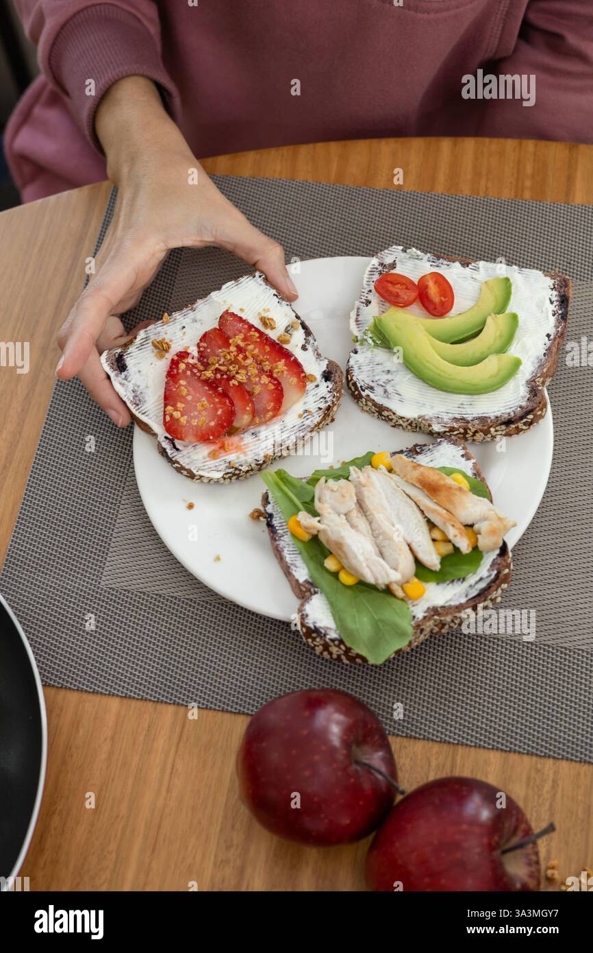 A graceful woman, elegantly dressed, enjoys a refined breakfast ...