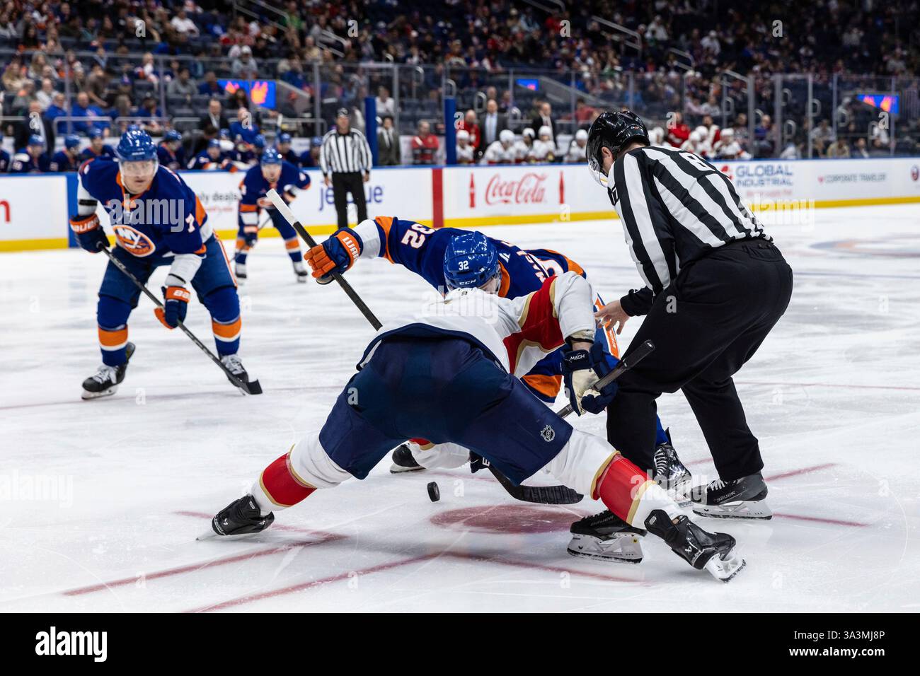 The puck drops for a face off between the New York Islanders and the Florida Panthers during the ...