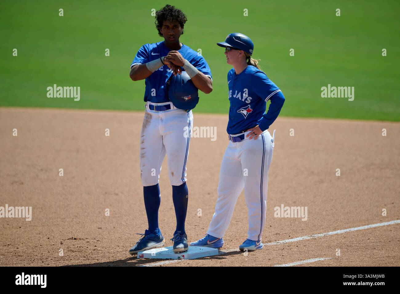 Toronto Blue Jays Arjun Nimmala (15) with coach Ashley Stephenson (2 ...