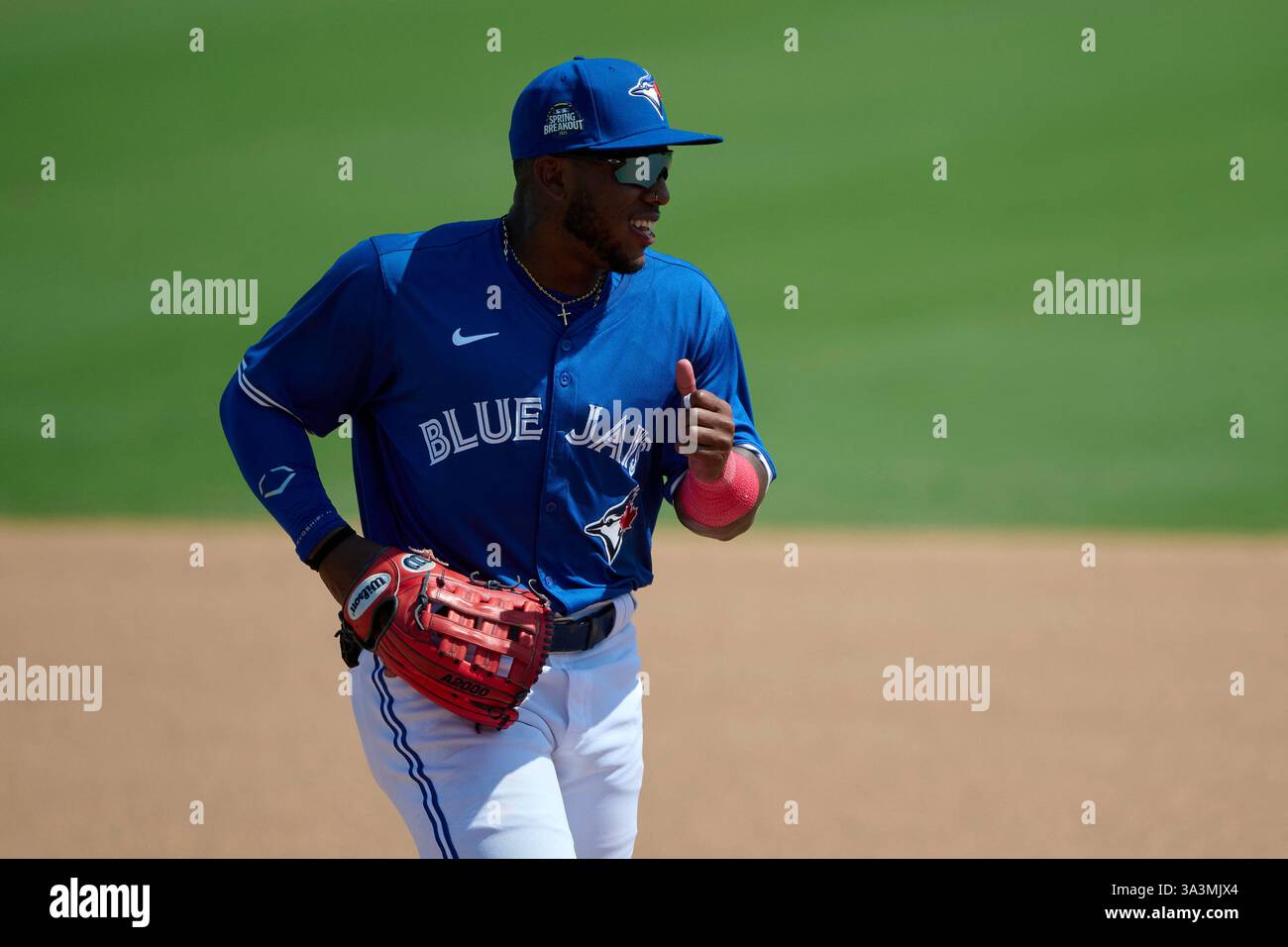 Toronto Blue Jays outfielder Victor Arias (41) jogs to the dugout ...