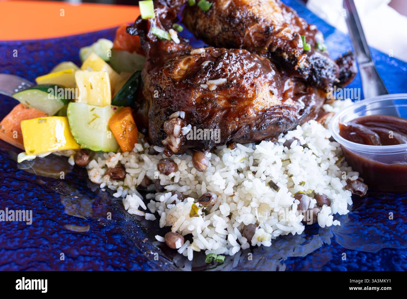 A Plate of Jerk Chicken with Rice and Beans Stock Photo - Alamy
