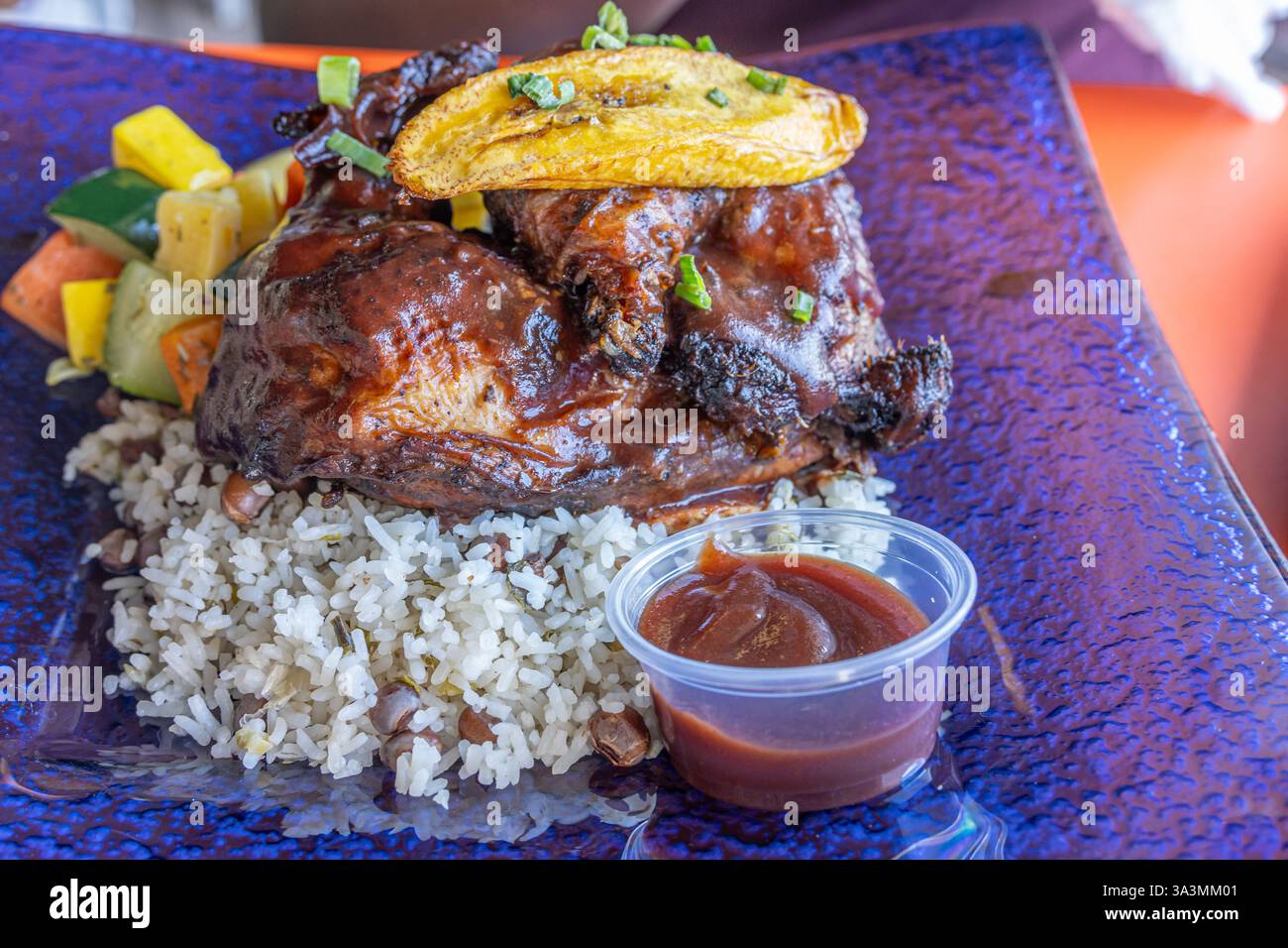 A Plate of Jerk Chicken with Rice and Beans Stock Photo - Alamy