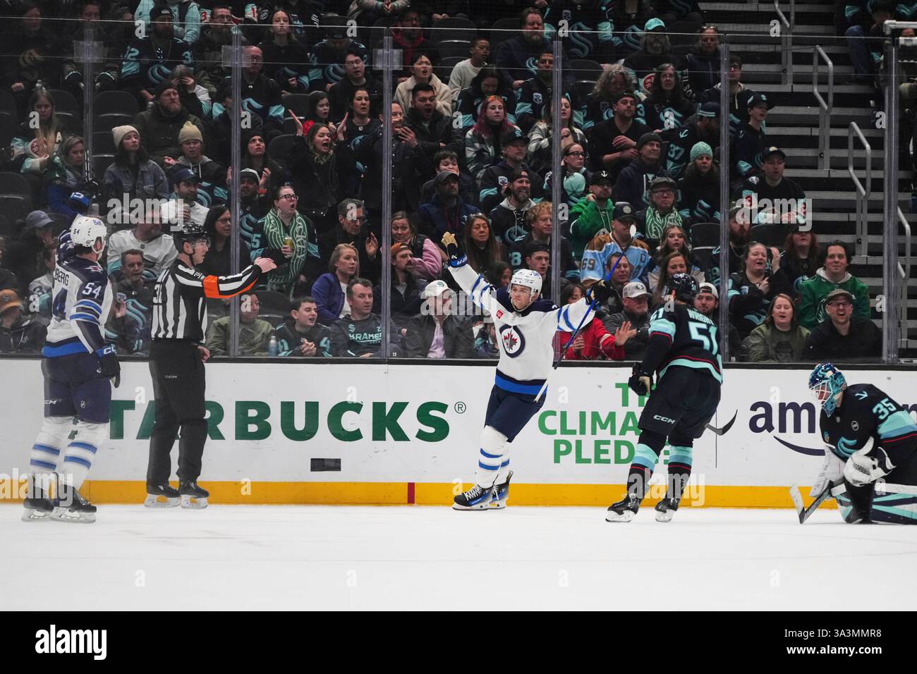 Winnipeg Jets defenseman Dylan Samberg, left, celebrates his winning ...