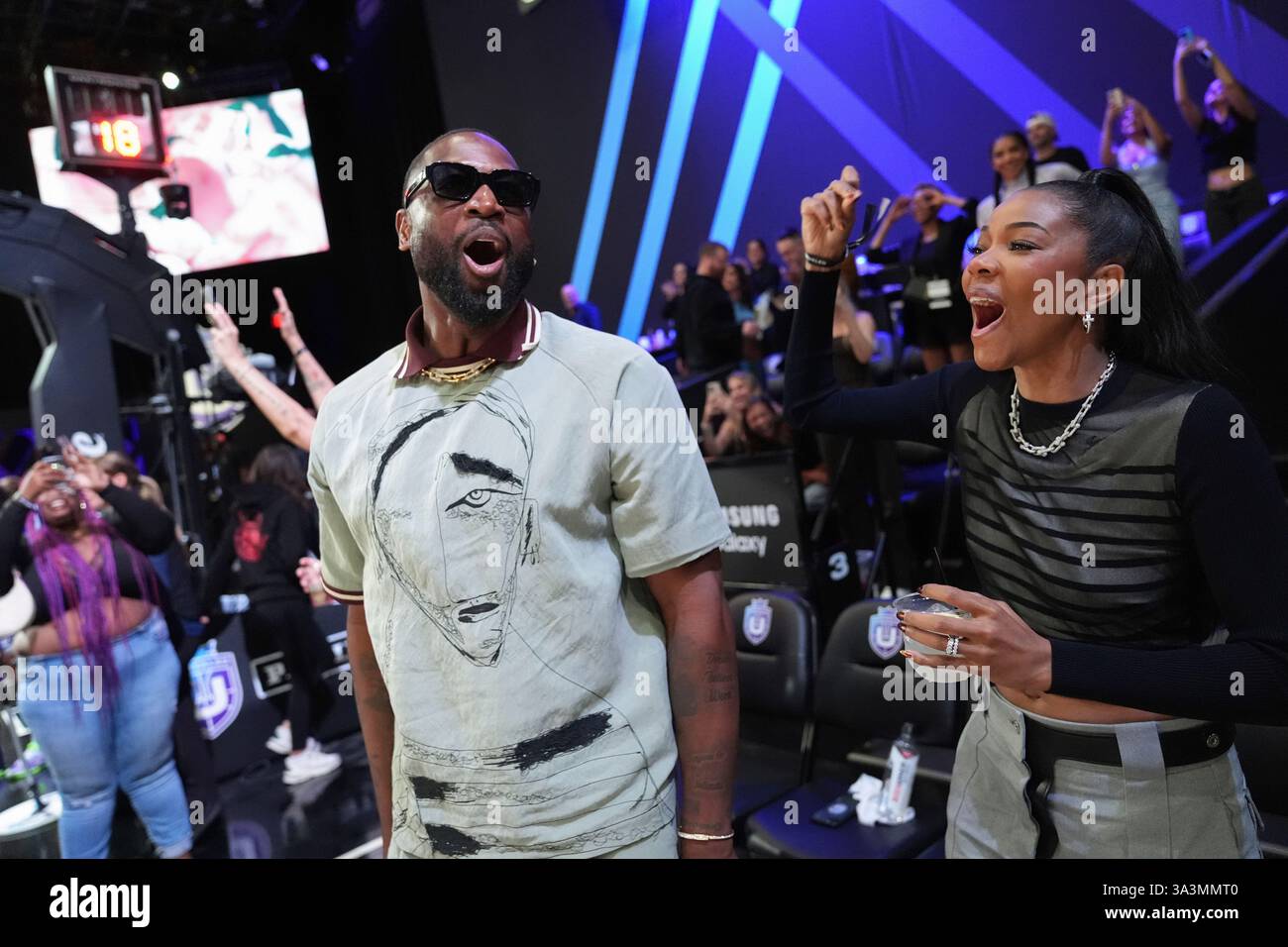 Former basketball player Dwayne Wade, center, and actor Gabrielle Union ...