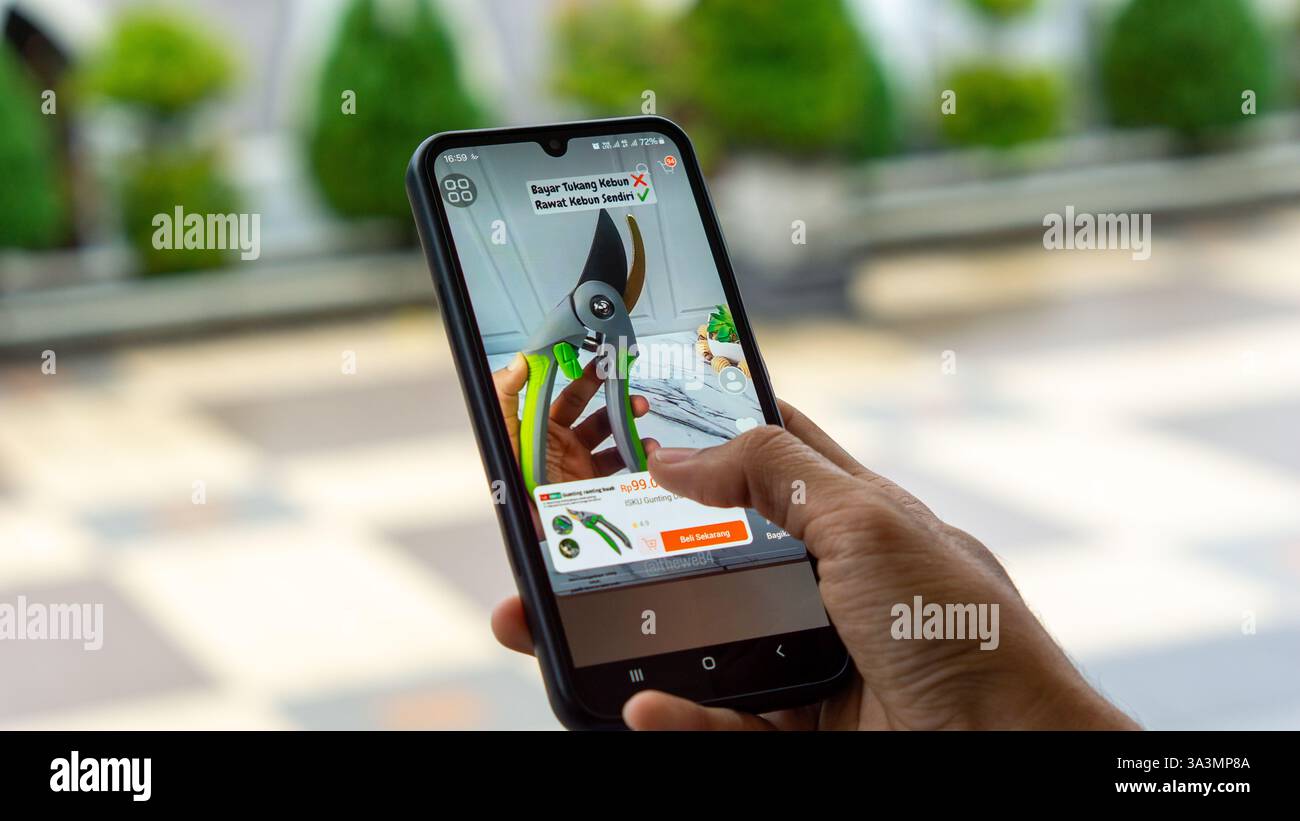 A hand is scrolling Shopee online shop Stock Photo - Alamy