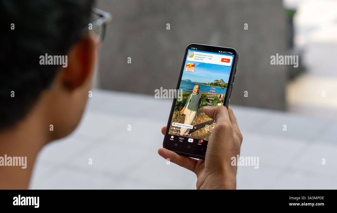 A hand is scrolling TikTok. Looking for entertainment to reduce fatigue ...