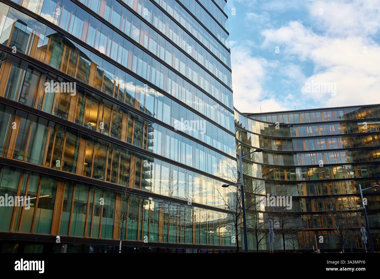 Modern glass skyscrapers reflecting blue sky and surrounding city. High ...