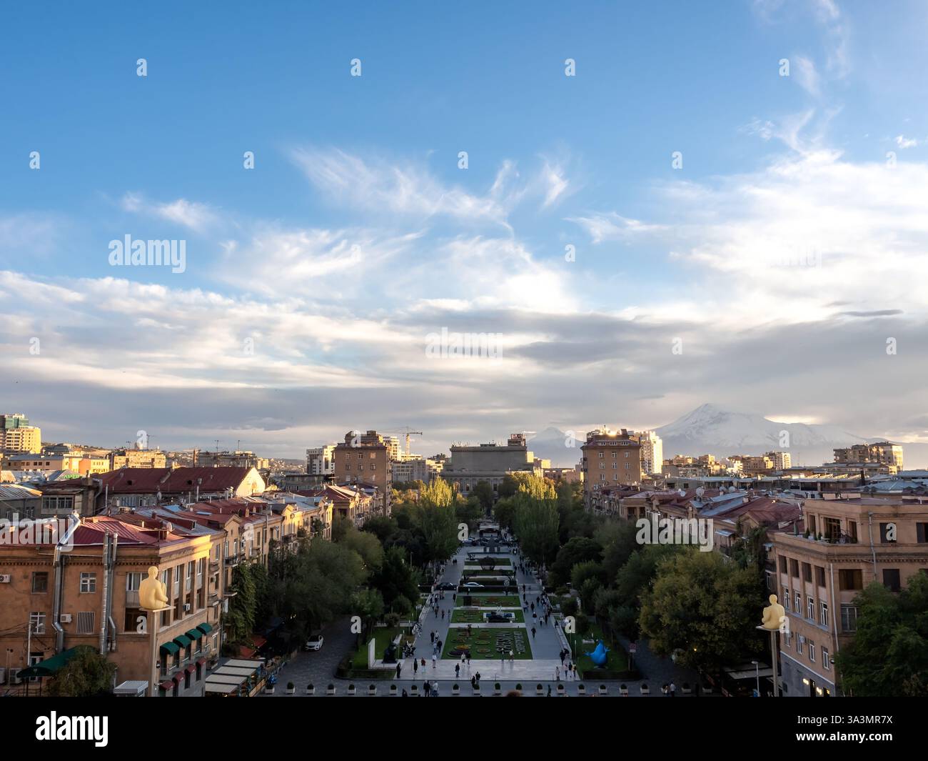 Scene of Yerevan cityscape with street buildings and trees, sunlight on ...