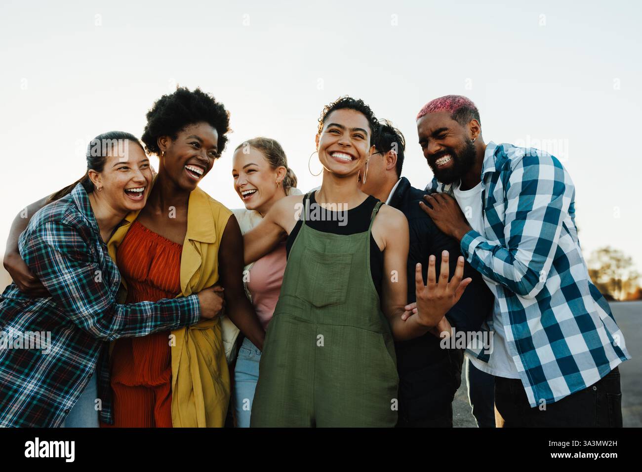 A diverse group of young individuals expressing joy and unity while ...