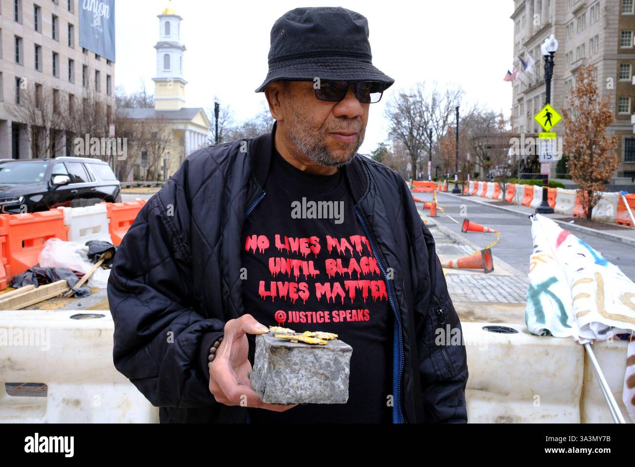 Washington DC, USA. 16th Mar, 2025. A person holds a brick and parts of ...