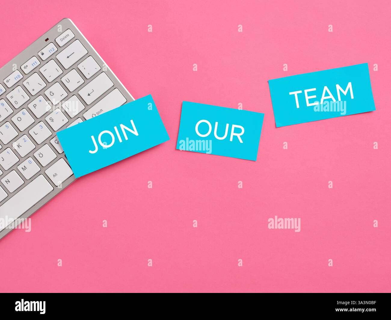 Sticky notes with join our team message and keyboard on pink background ...