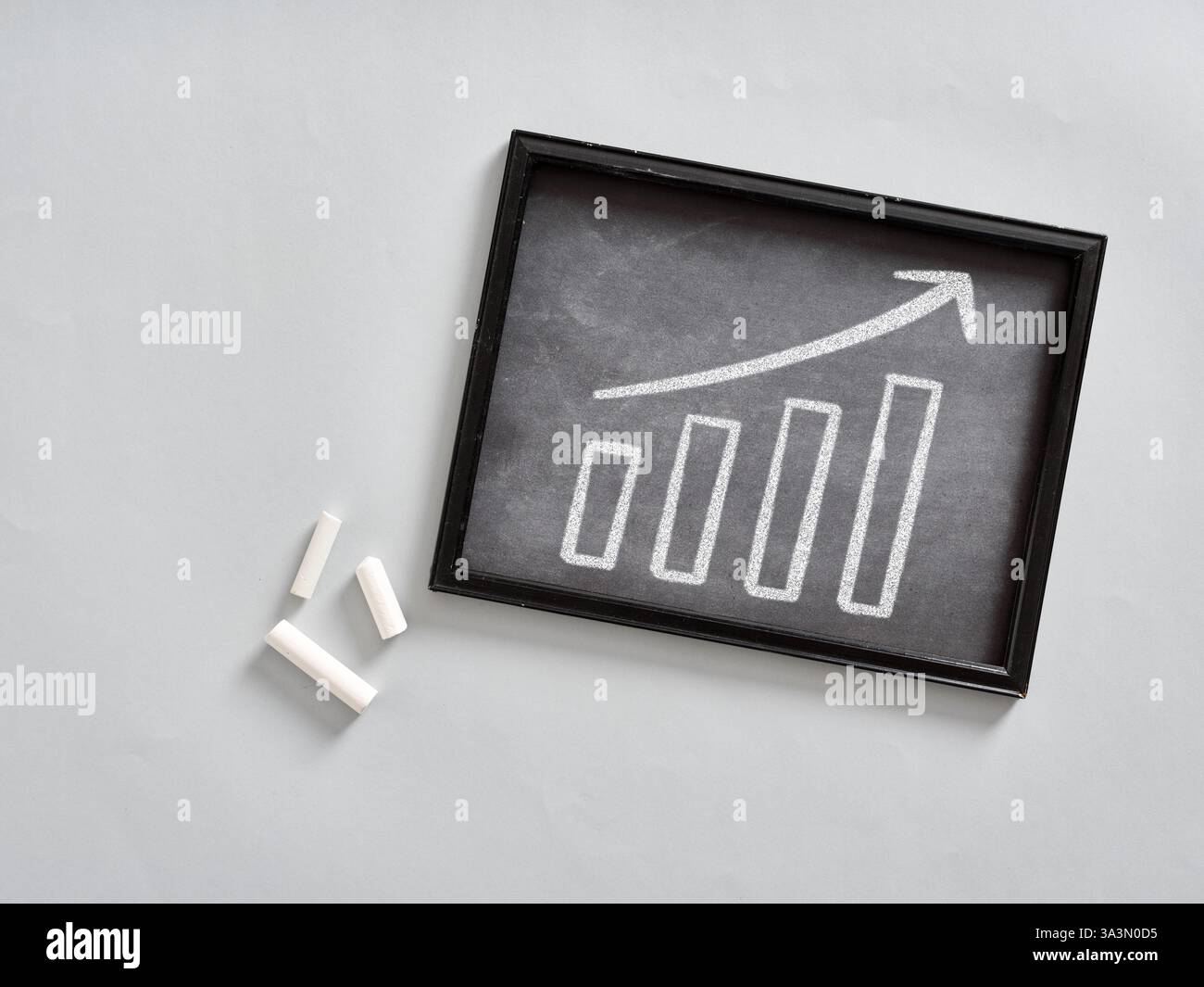 Bar chart drawn in chalk on a blackboard showing growth and improvement ...