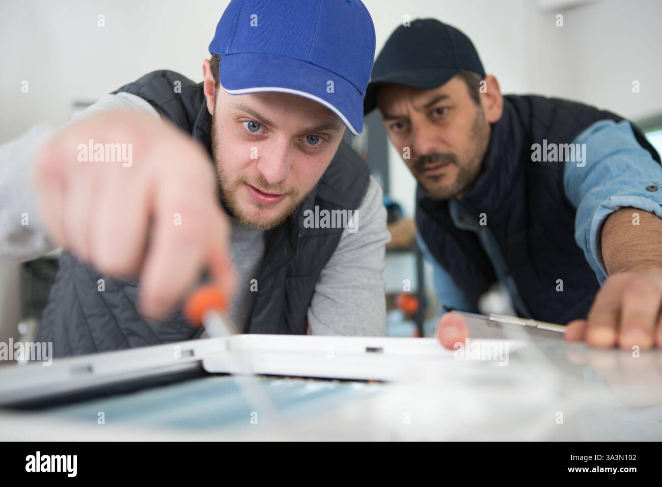 pvc installation apprentice is having lesson Stock Photo - Alamy