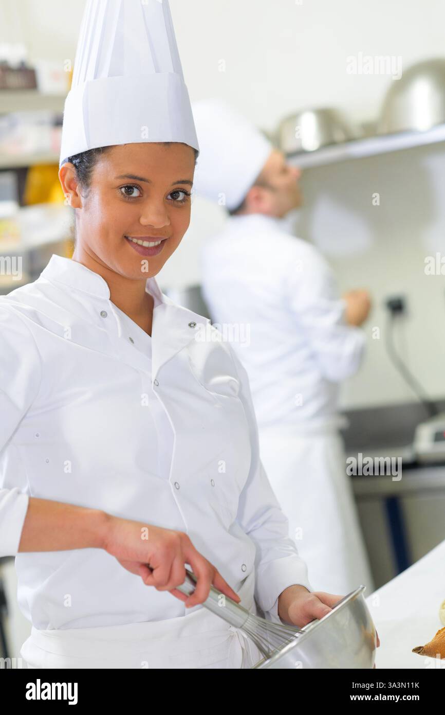 female young chef mixing something in the bowl Stock Photo - Alamy