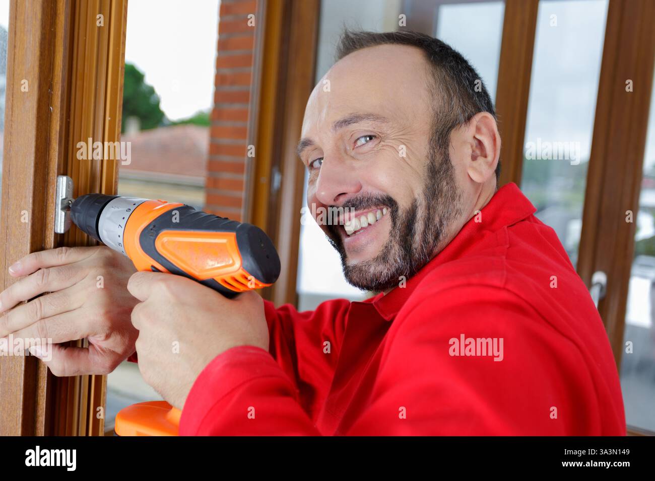 happy smiling foreman keeping drill Stock Photo - Alamy